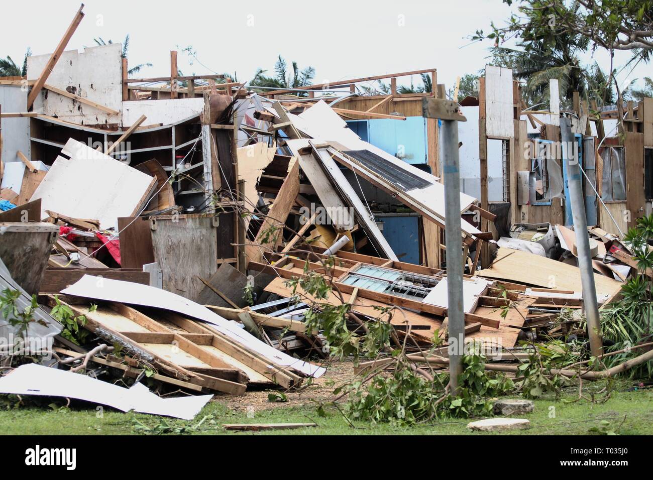 The damaged remains of wooden houses after a typhoon hit a tropical ...