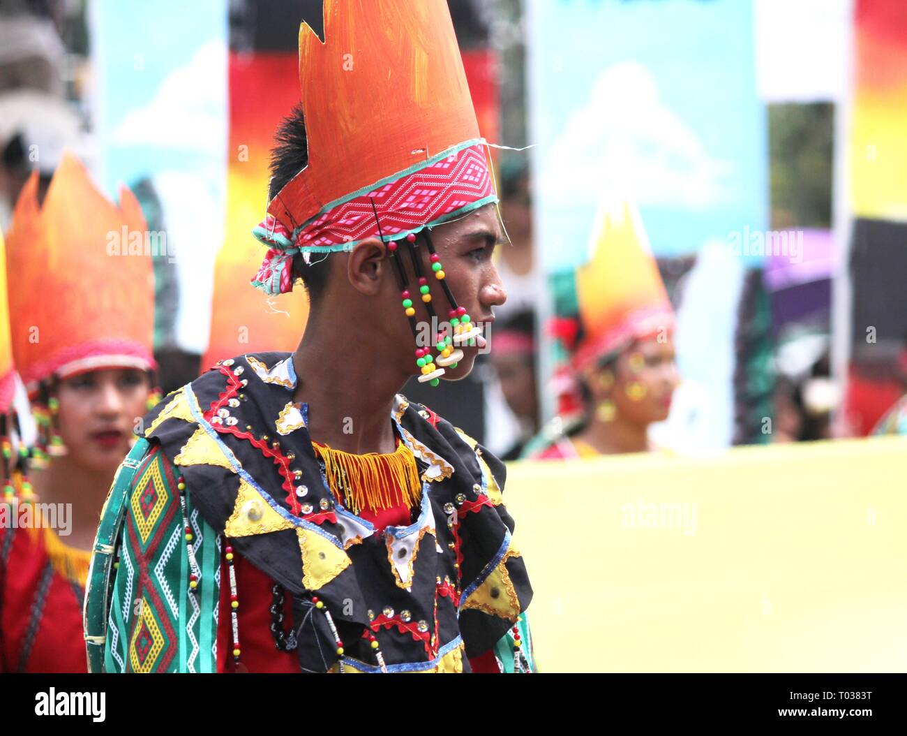 DAVAO CITY, PHILIPPINES—AUGUST 2014: A boy with colorful headdress and ...
