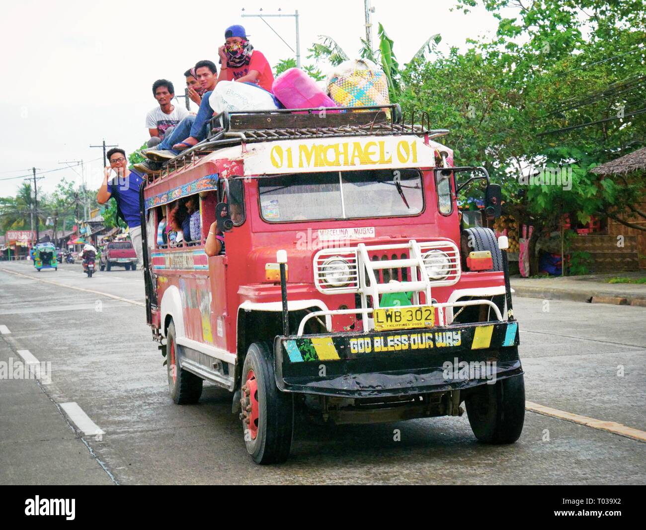 TAGUM CITY, PHILIPPINES—FEBRUARY 2016: Passengers ride on the rooftop ...