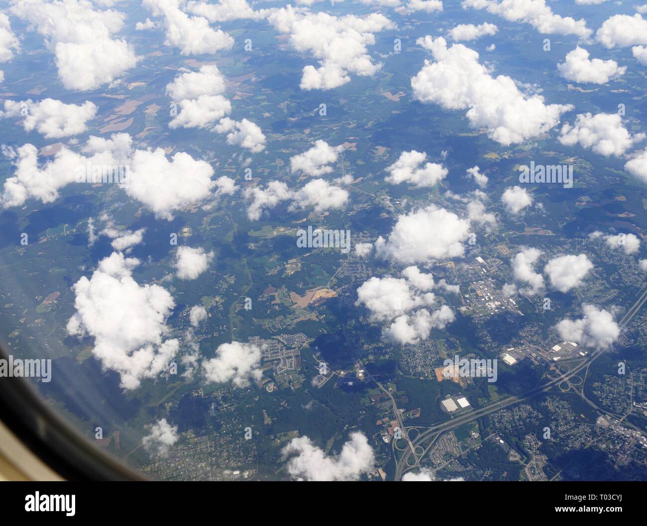 Aerial view above Atlanta, Georgia with fluffy white clouds seen from ...