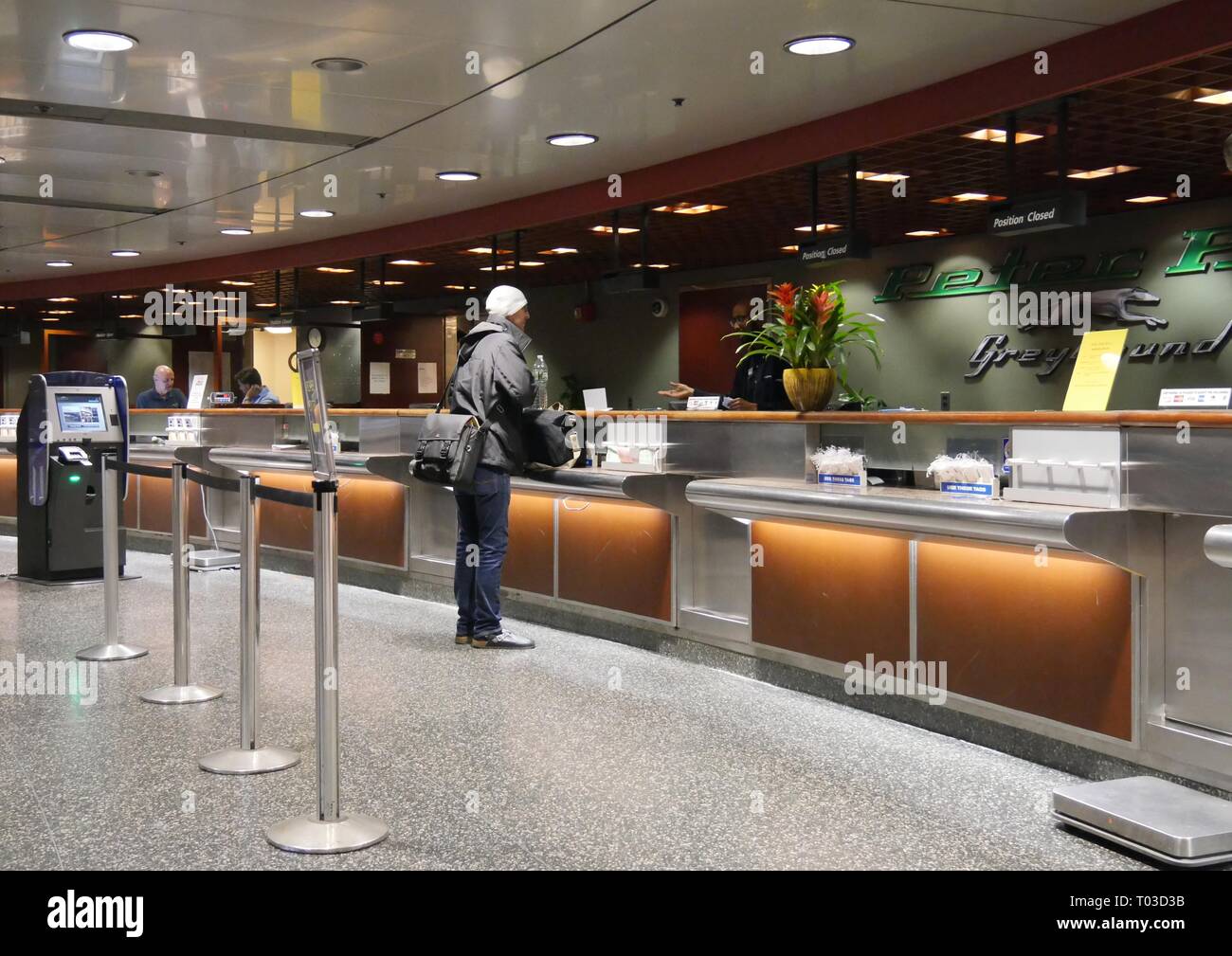 BOSTON, MASSACHUSETTS—SEPTEMBER 2017: A man buys a bus ticket from the ...