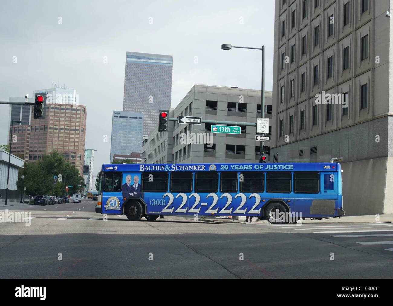 DENVER, COLORADO—OCTOBER 2017:A blue bus crosses an intersection at ...