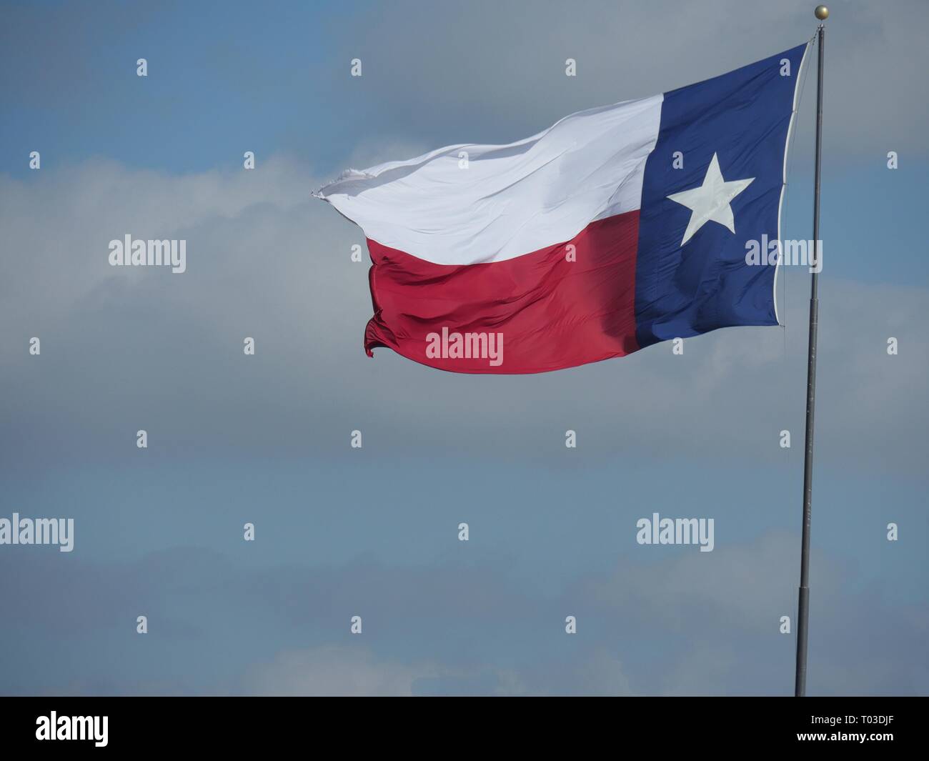 Texas state flag flying in the skies from a pole Stock Photo - Alamy