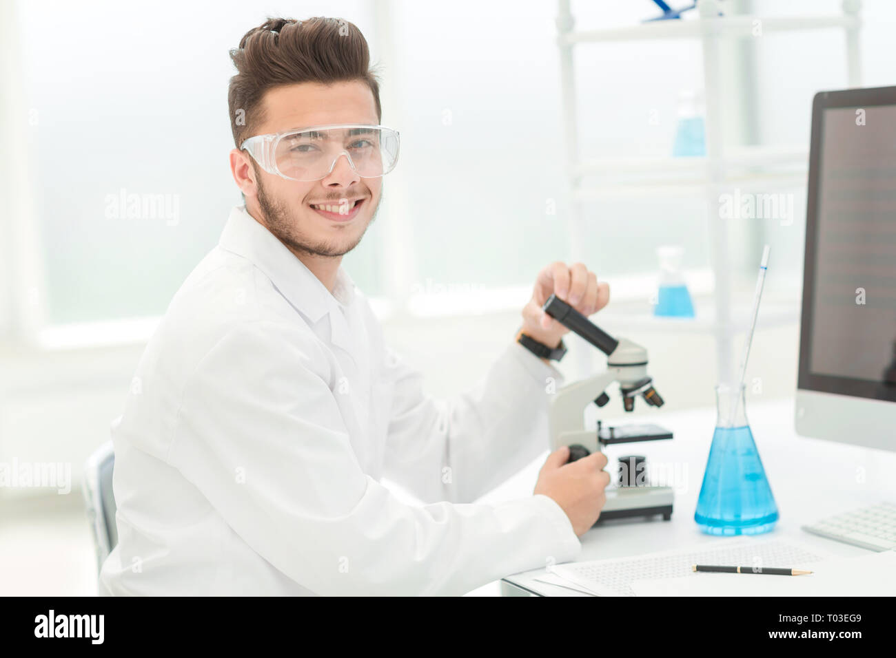 modern scientist sitting at his Desk in the laboratory Stock Photo - Alamy