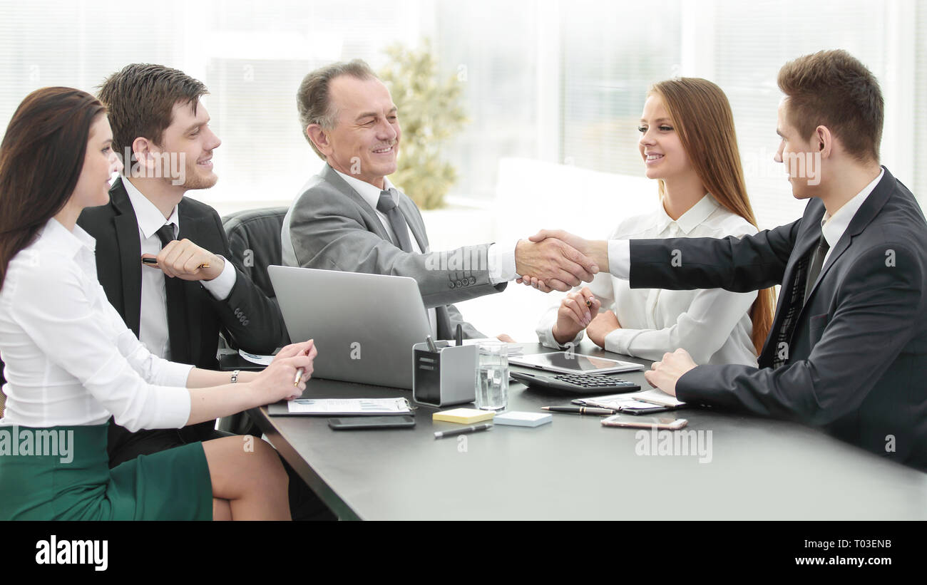 businessman and investor shake hands at the negotiating table Stock ...