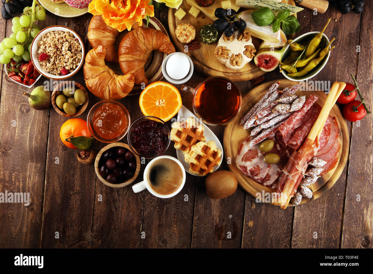 breakfast on table with bread buns, croissants, coffe and donuts Stock ...