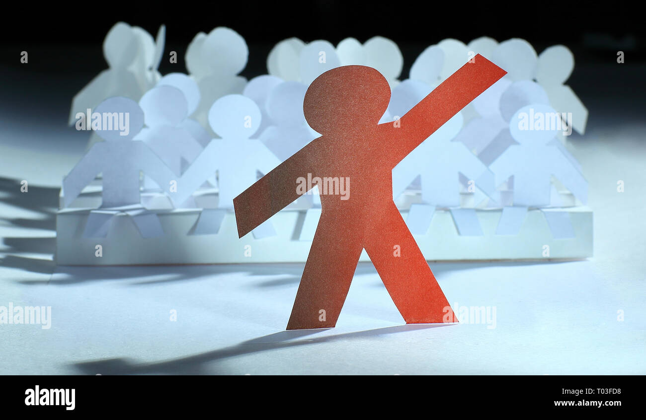 leader standing in front of a group of paper doll Stock Photo - Alamy