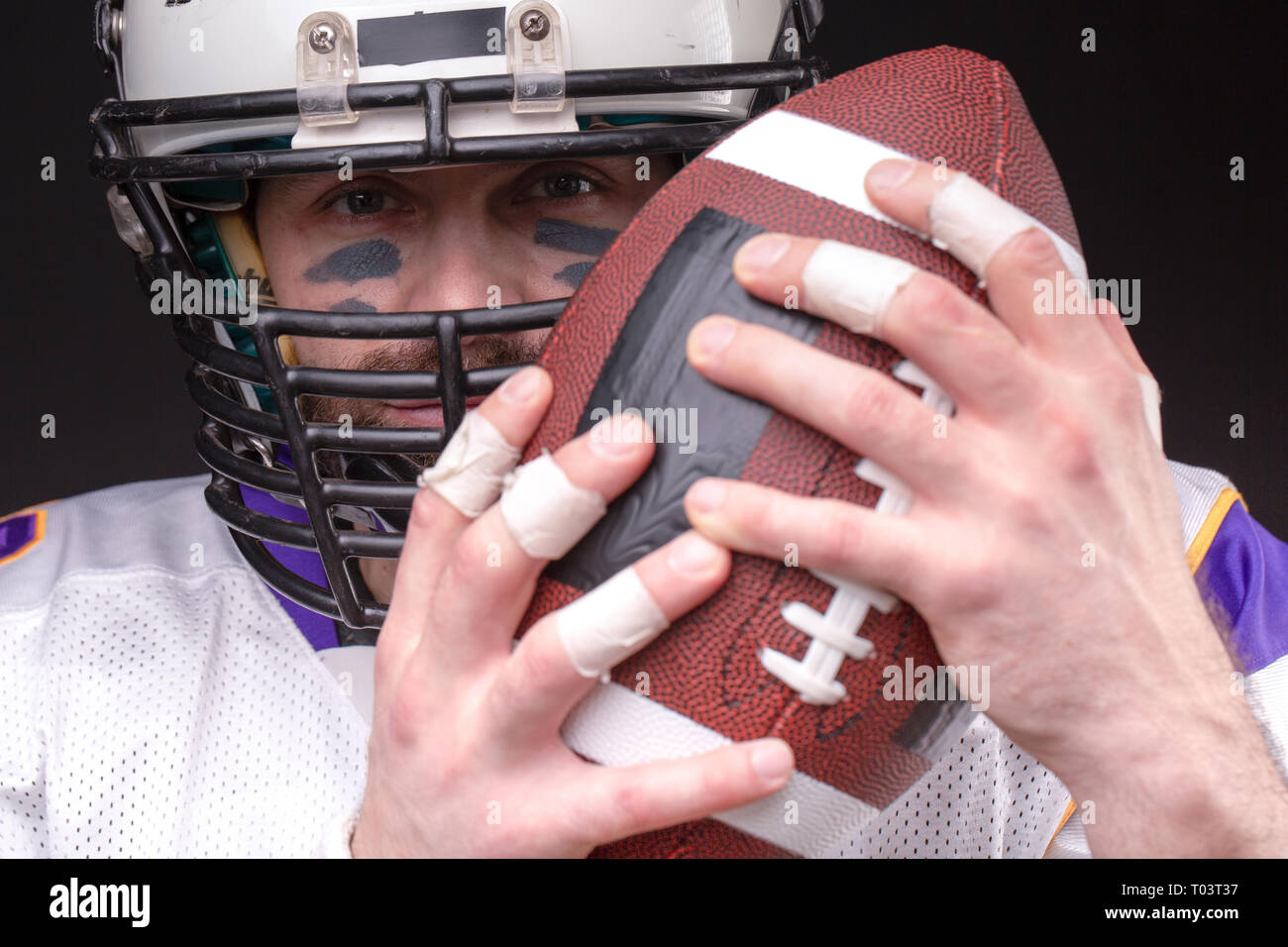 Ball for American football in front of footballer face Stock Photo - Alamy