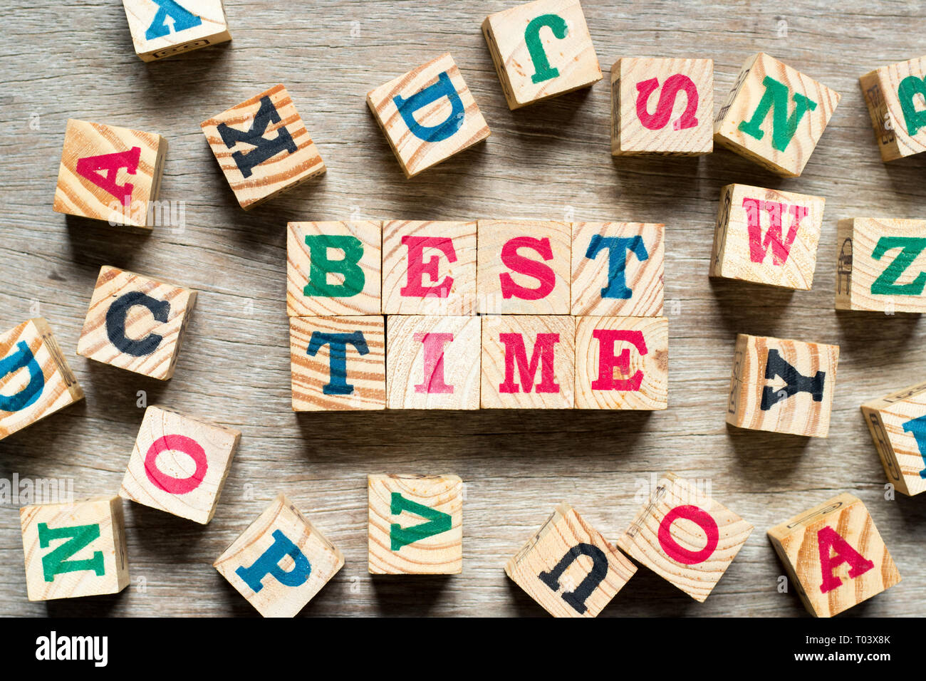 Letter block in word best time with another alphabet on wood background ...