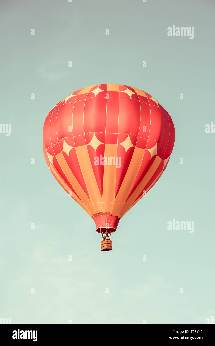 Orange hot air balloon in the sky. Retro styled image Stock Photo - Alamy