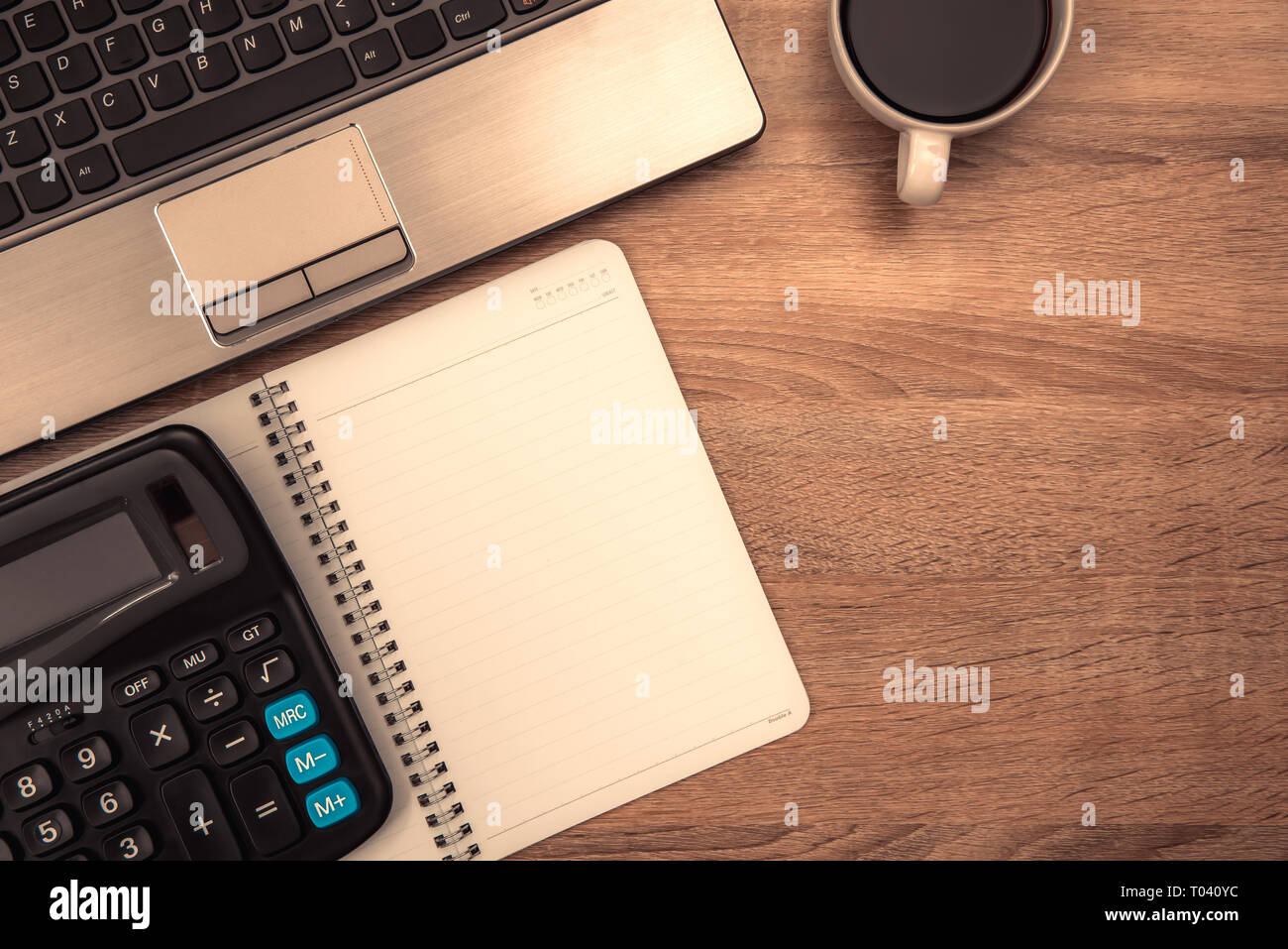 Laptop computer or notebook, calculator and cup of coffee on working ...