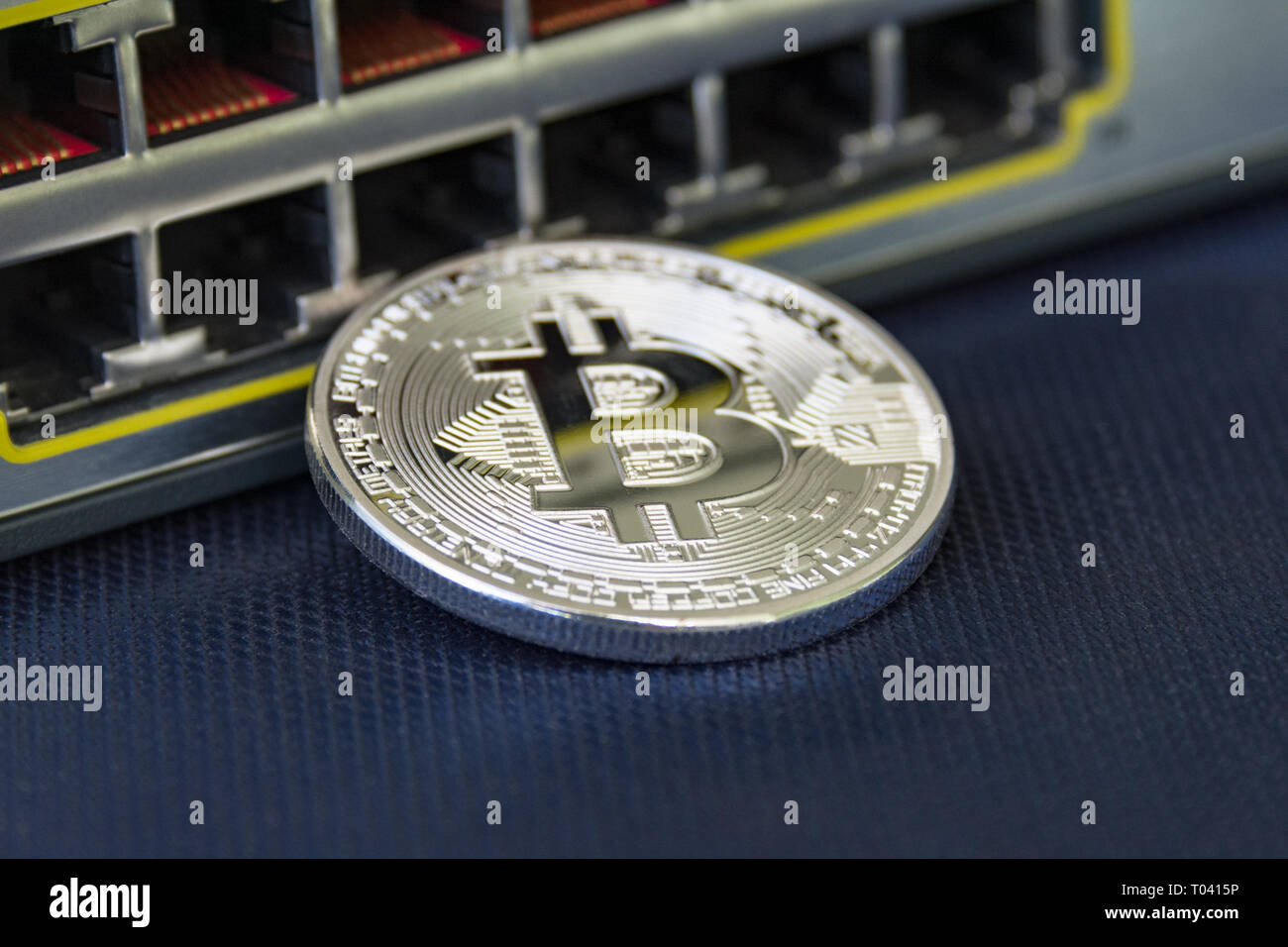 Mint bitcoin with ethernet ports on the background Stock Photo - Alamy