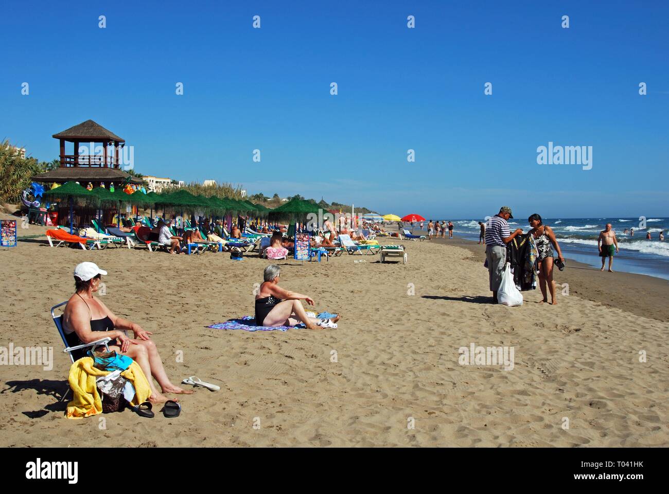 Tourists relaxing on Playa de la Vibora beach, Elviria, Marbella ...