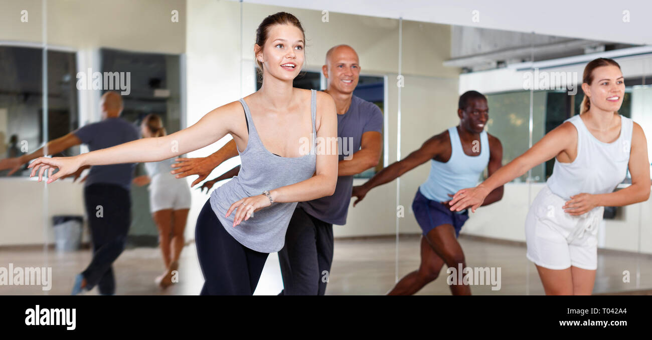 Cheerful positive glad people practicing vigorous lindy hop movements ...