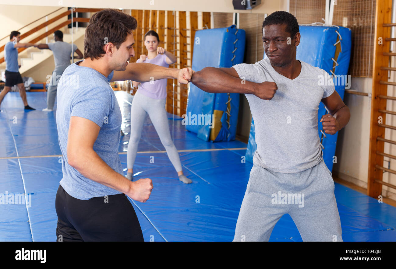 Males training attack movements in pair at self protection workout ...