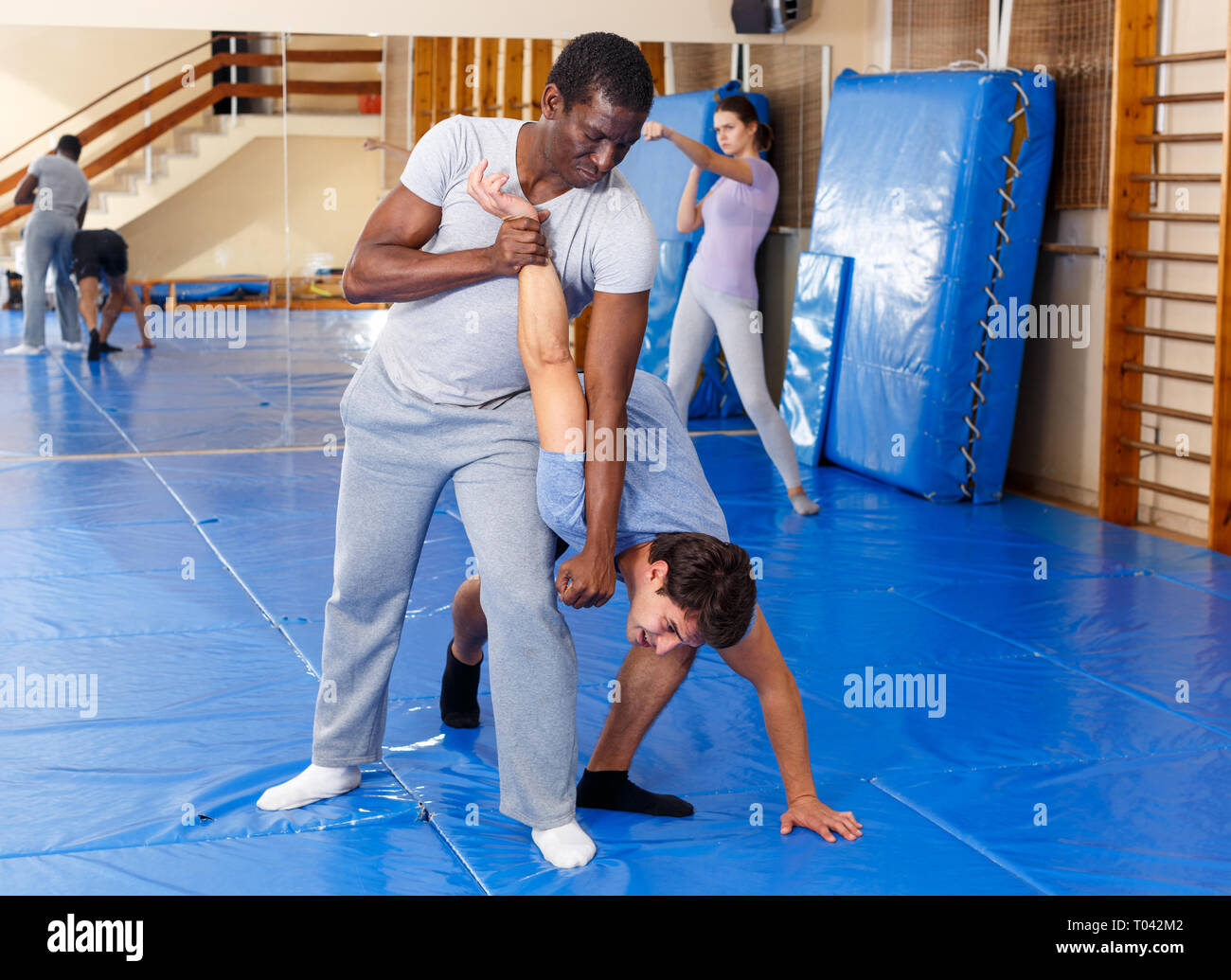 Men practicing effective techniques of self-defence during individual ...