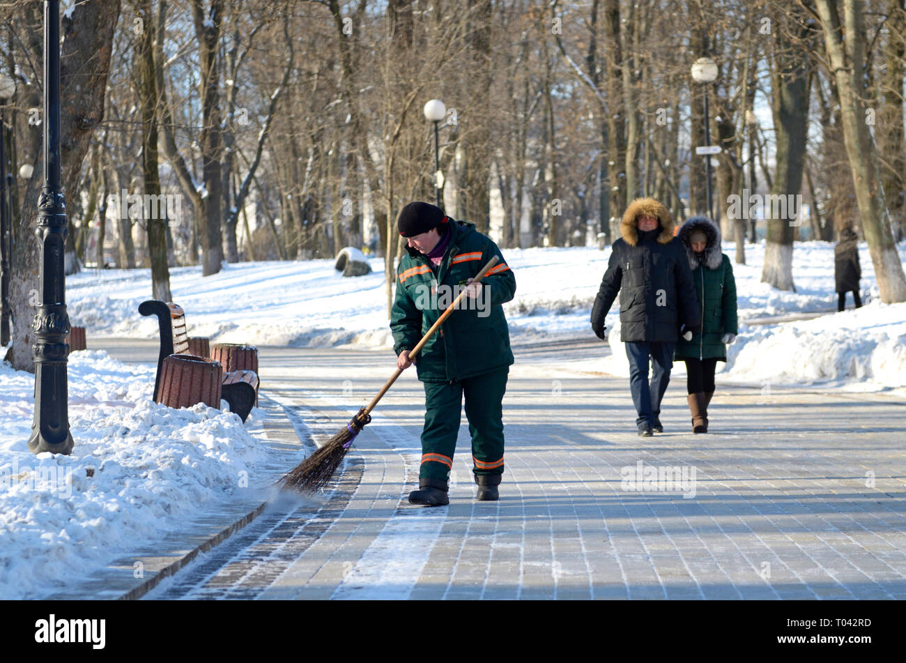 Sweeping snow with a broom hi-res stock photography and images - Alamy