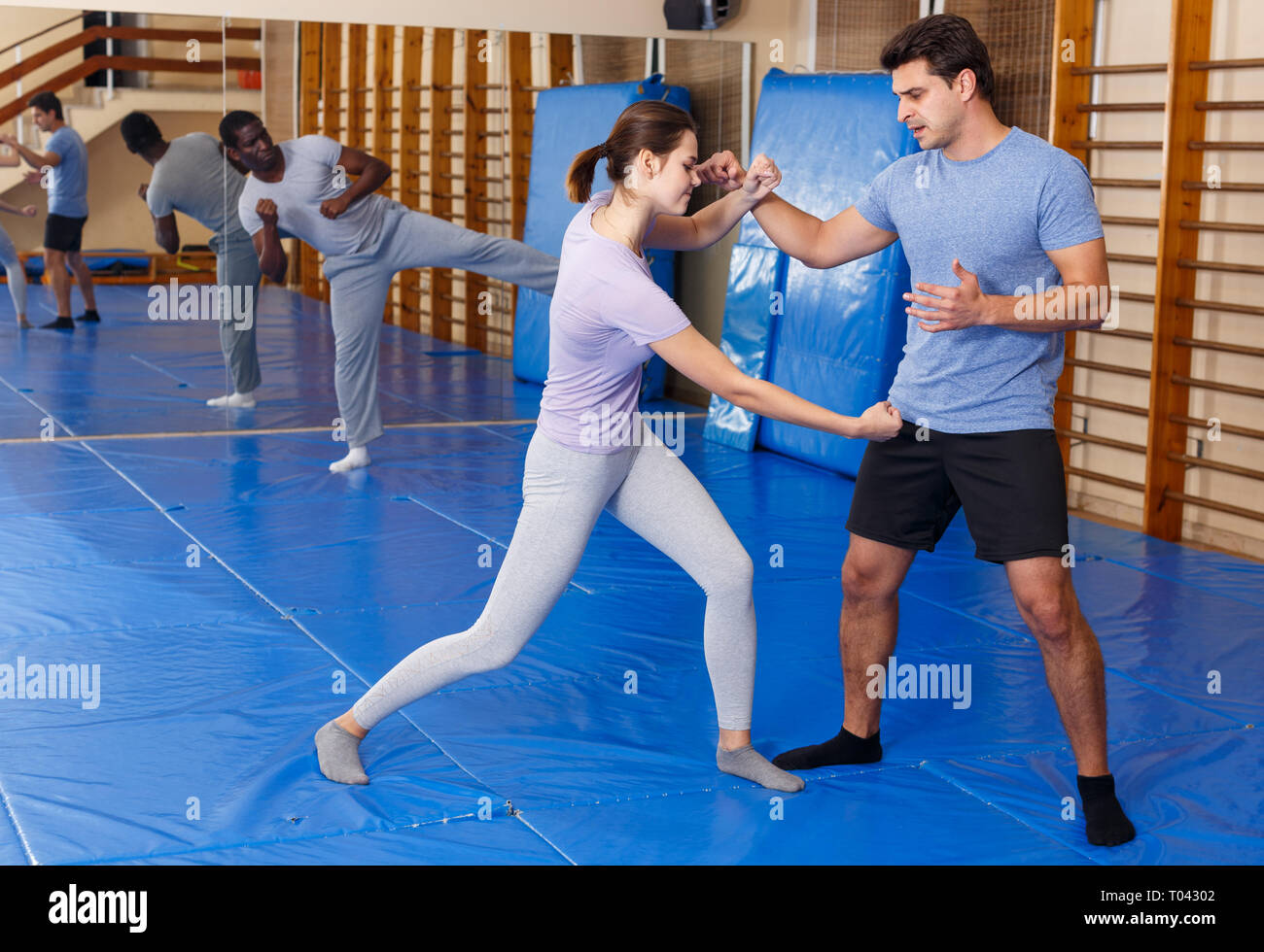 Young man and woman at self protection workout, training attack ...