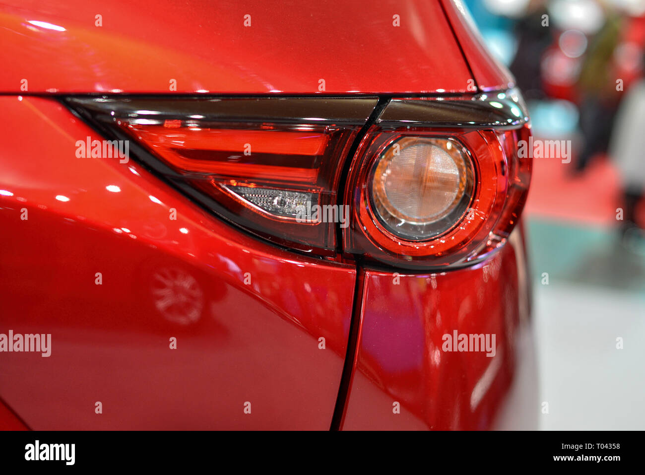 Car headlight with backlight. Exterior detail.Red color car Stock Photo ...