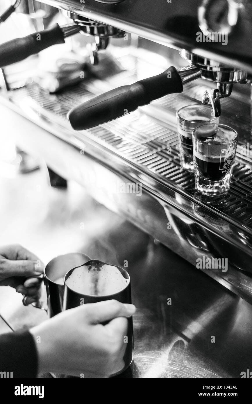 making espresso coffee BW black and white close up detail with modern ...