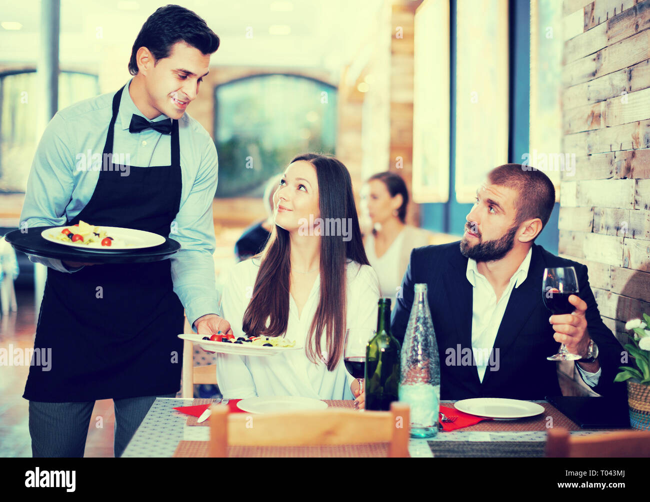 Professional positive waiter man hi-res stock photography and images ...