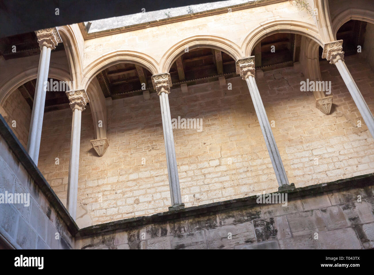 Gothic arched gallery with porphyry columns leading on royal residence ...