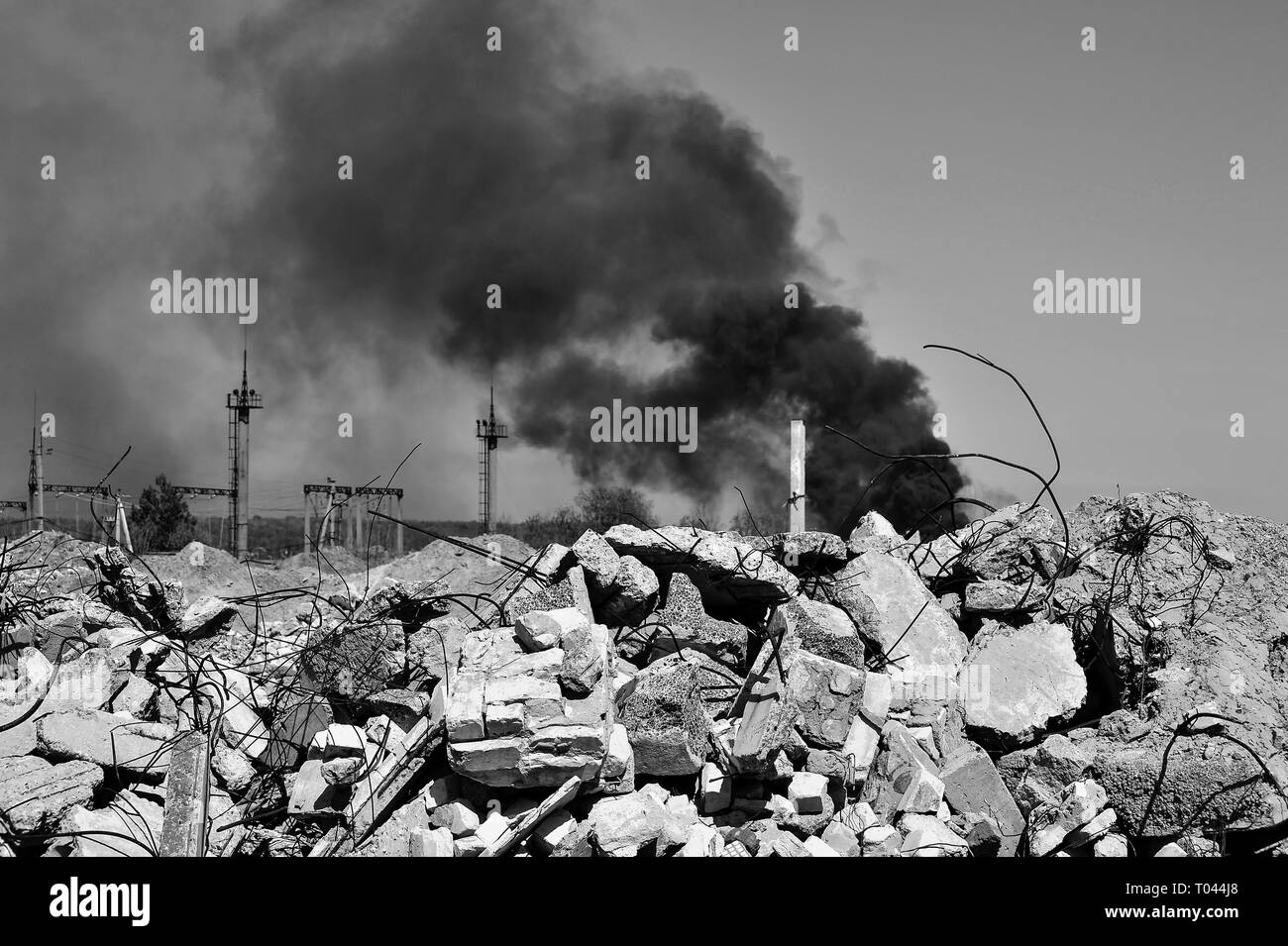 A pile of concrete rubble with protruding rebar on the background of ...