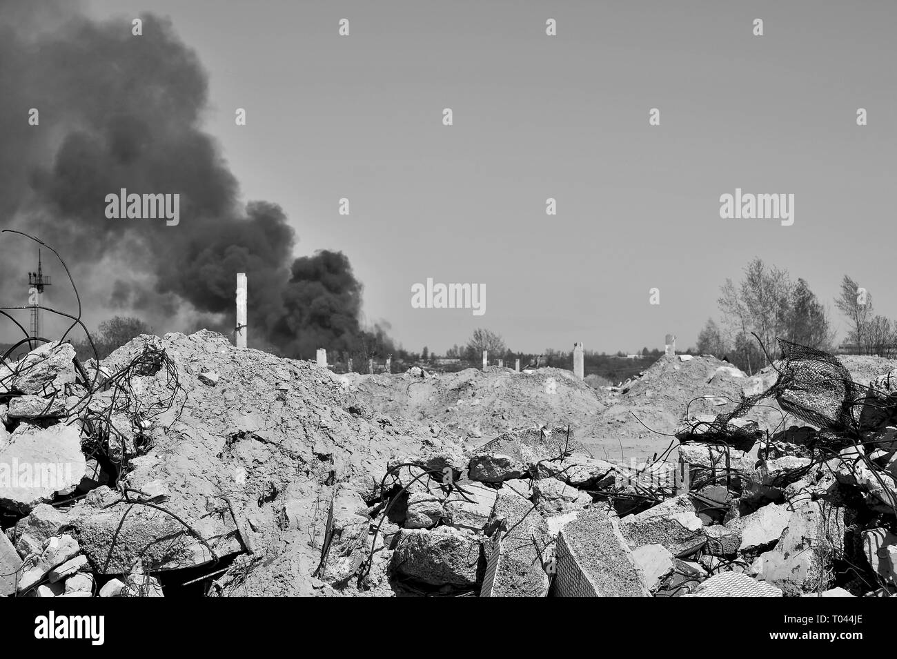 A pile of concrete rubble with protruding rebar on the background of ...