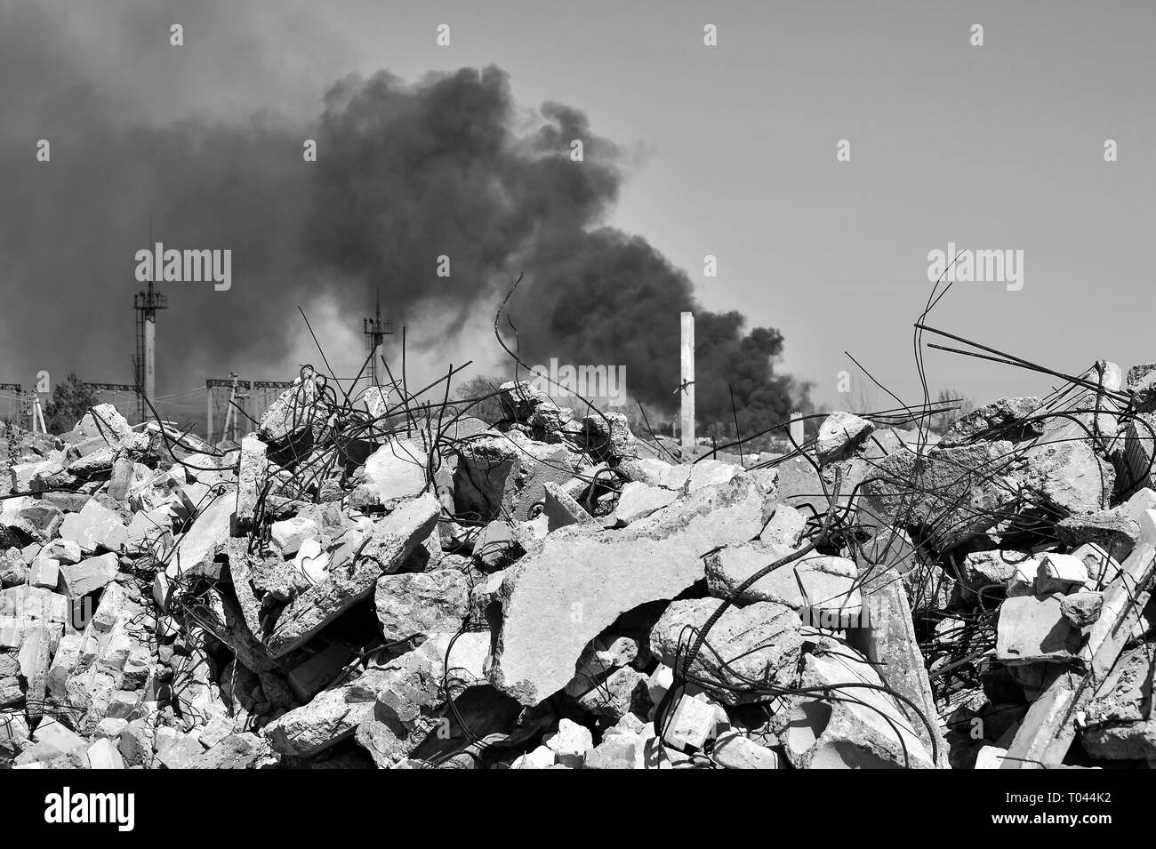 A pile of concrete rubble with protruding rebar on the background of ...