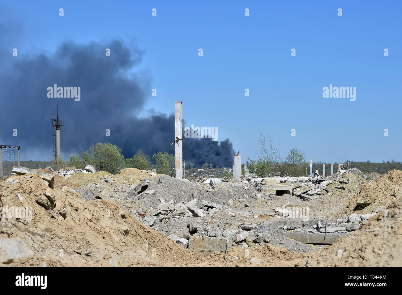 A pile of concrete rubble with protruding rebar on the background of ...