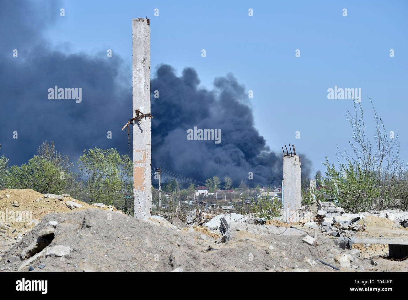 A pile of concrete rubble with protruding rebar on the background of ...