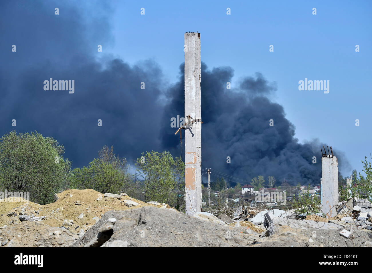 A pile of concrete rubble with protruding rebar on the background of ...