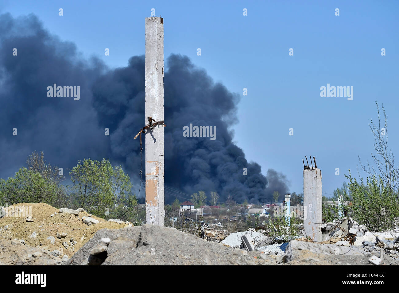 A pile of concrete rubble with protruding rebar on the background of ...
