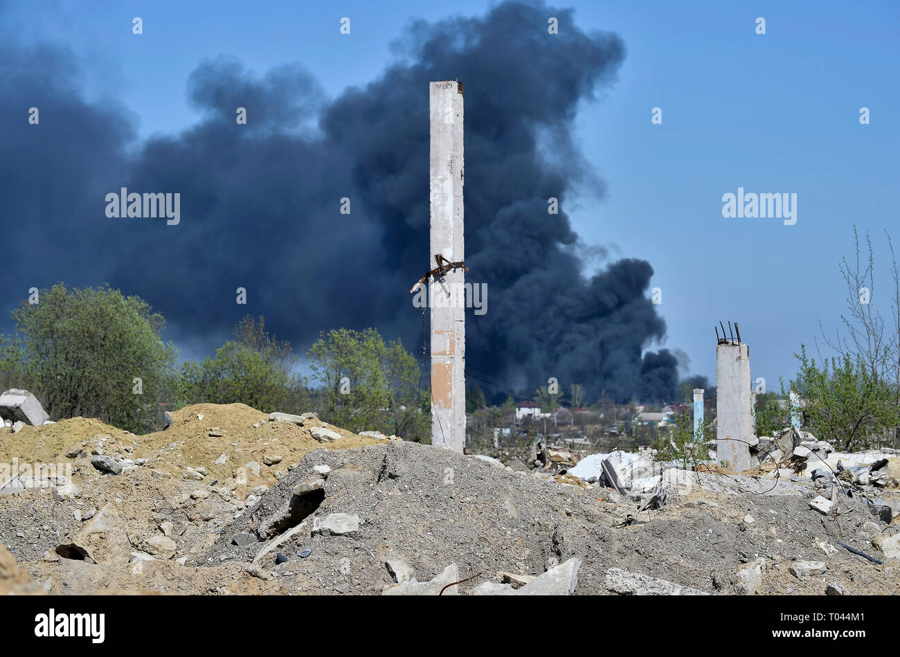A pile of concrete rubble with protruding rebar on the background of ...