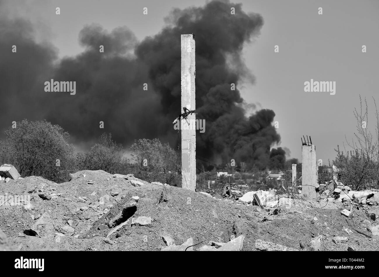 A pile of concrete rubble with protruding rebar on the background of ...