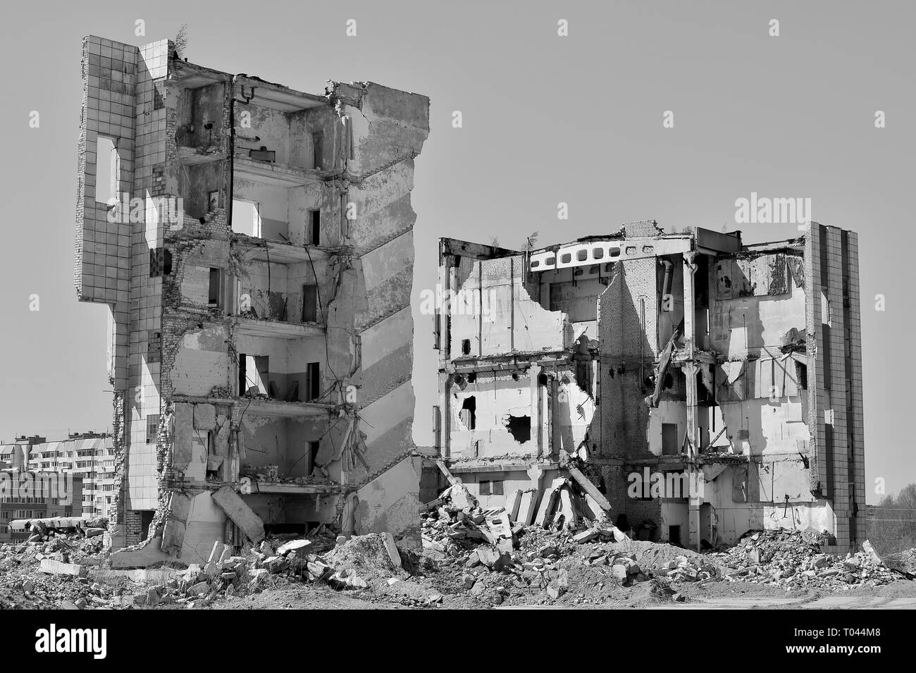 A pile of concrete debris on the background of a large destroyed ...