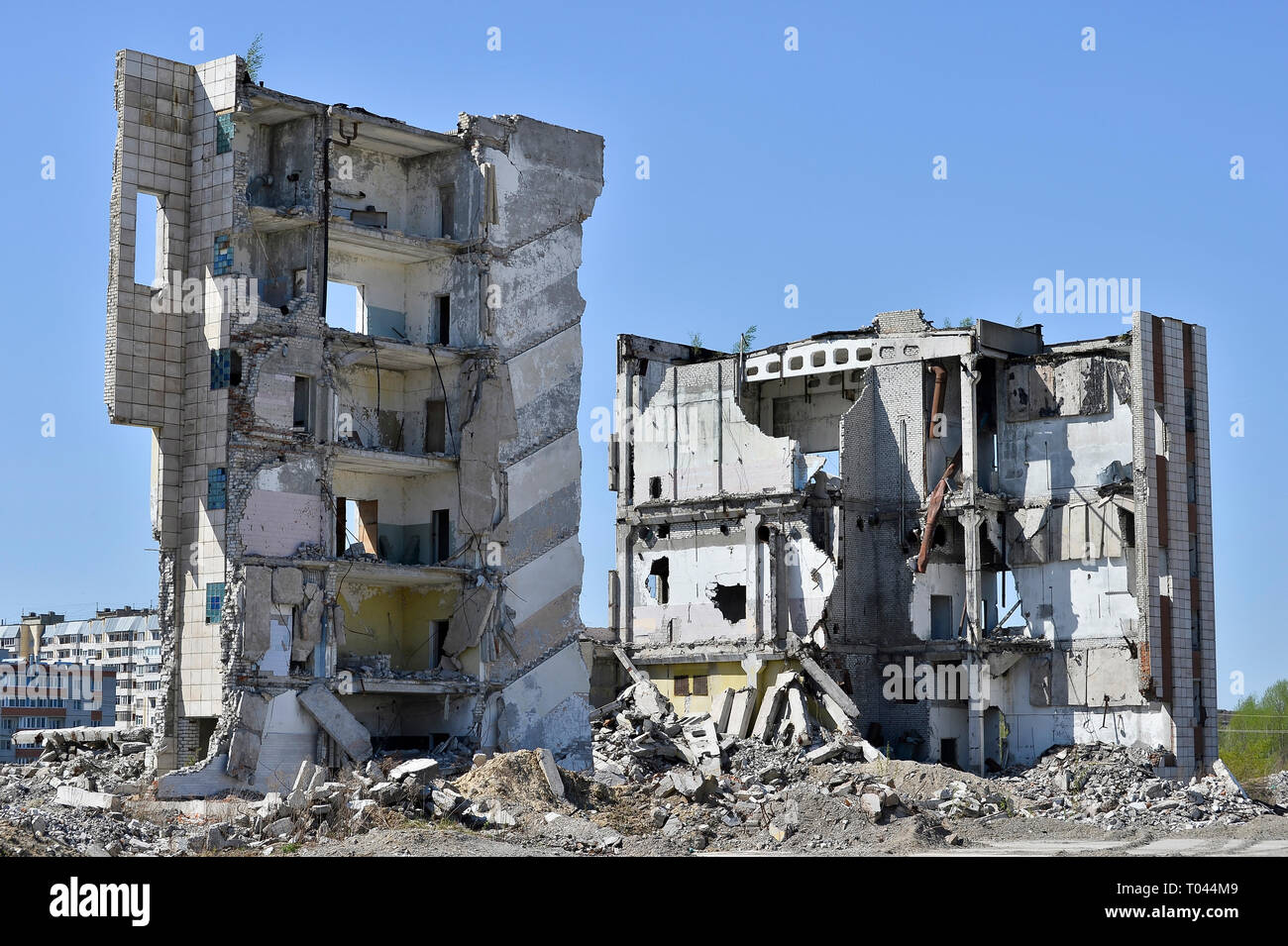 A pile of concrete debris on the background of a large destroyed ...