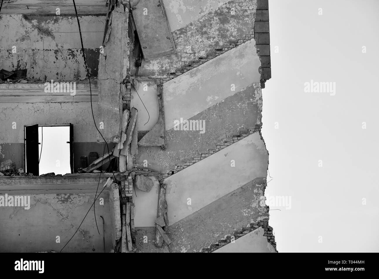 The remains of the destroyed concrete wall of a large building with ...