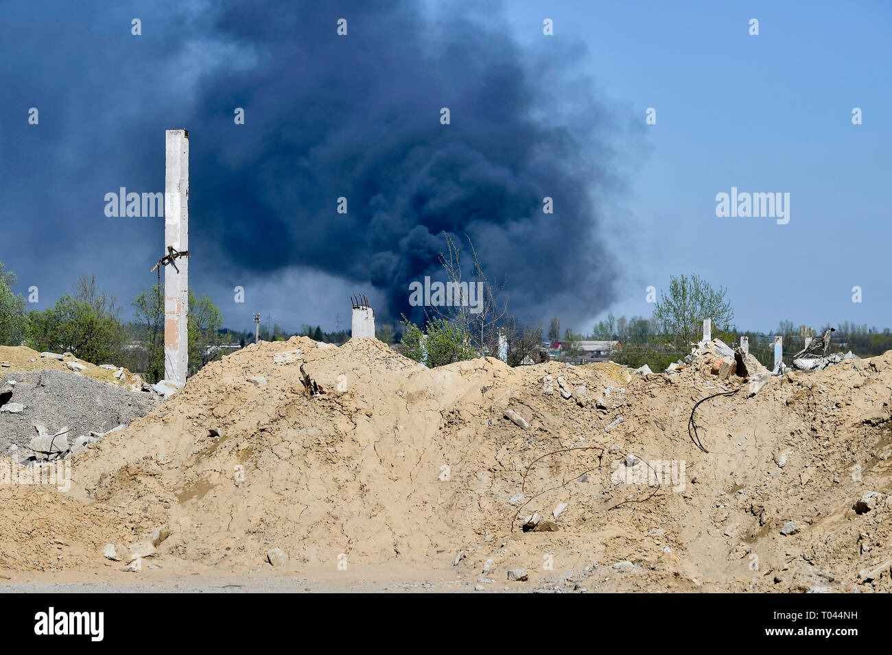 A pile of concrete rubble with protruding rebar on the background of ...