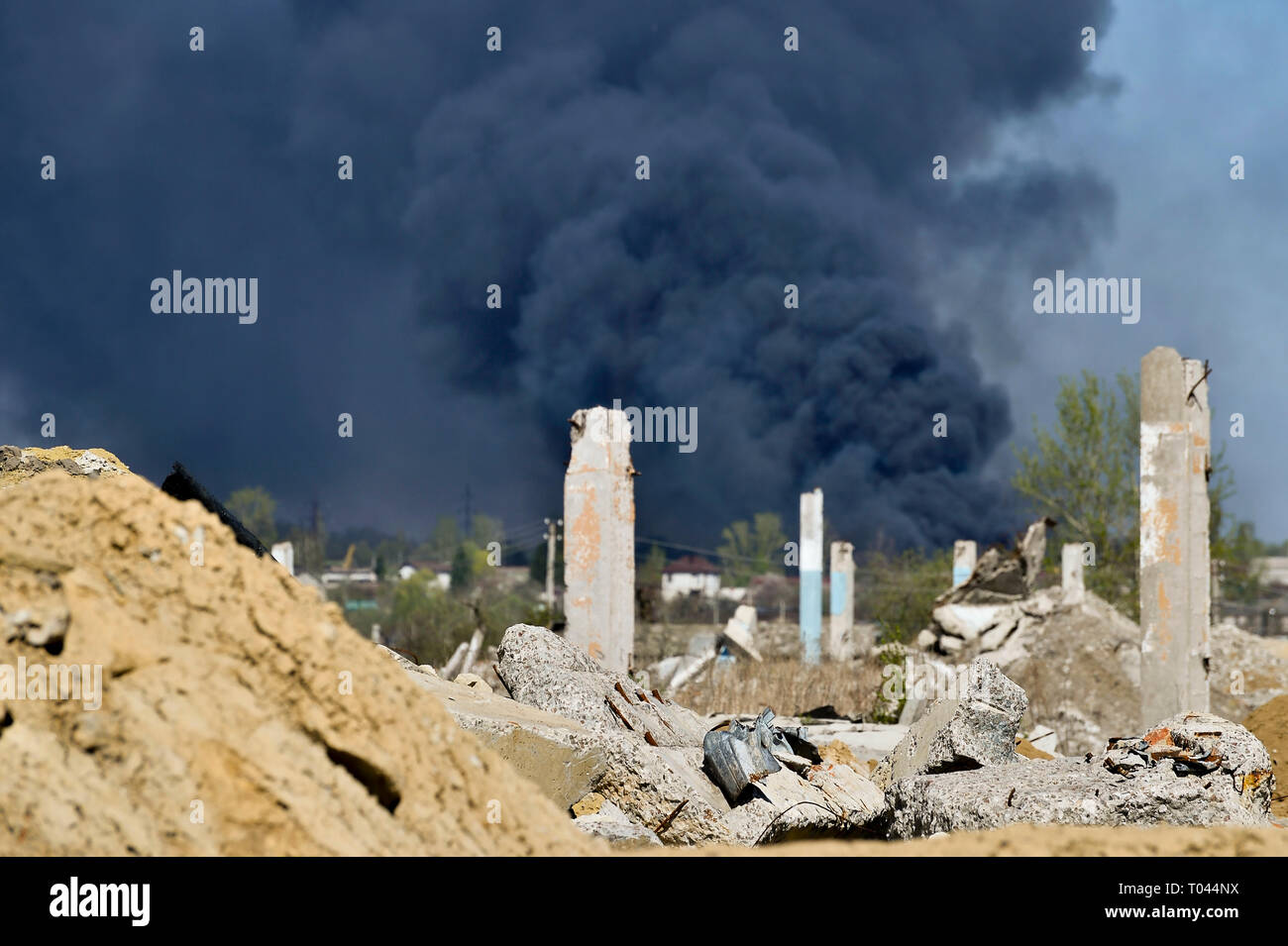 A pile of concrete rubble with protruding rebar on the background of ...