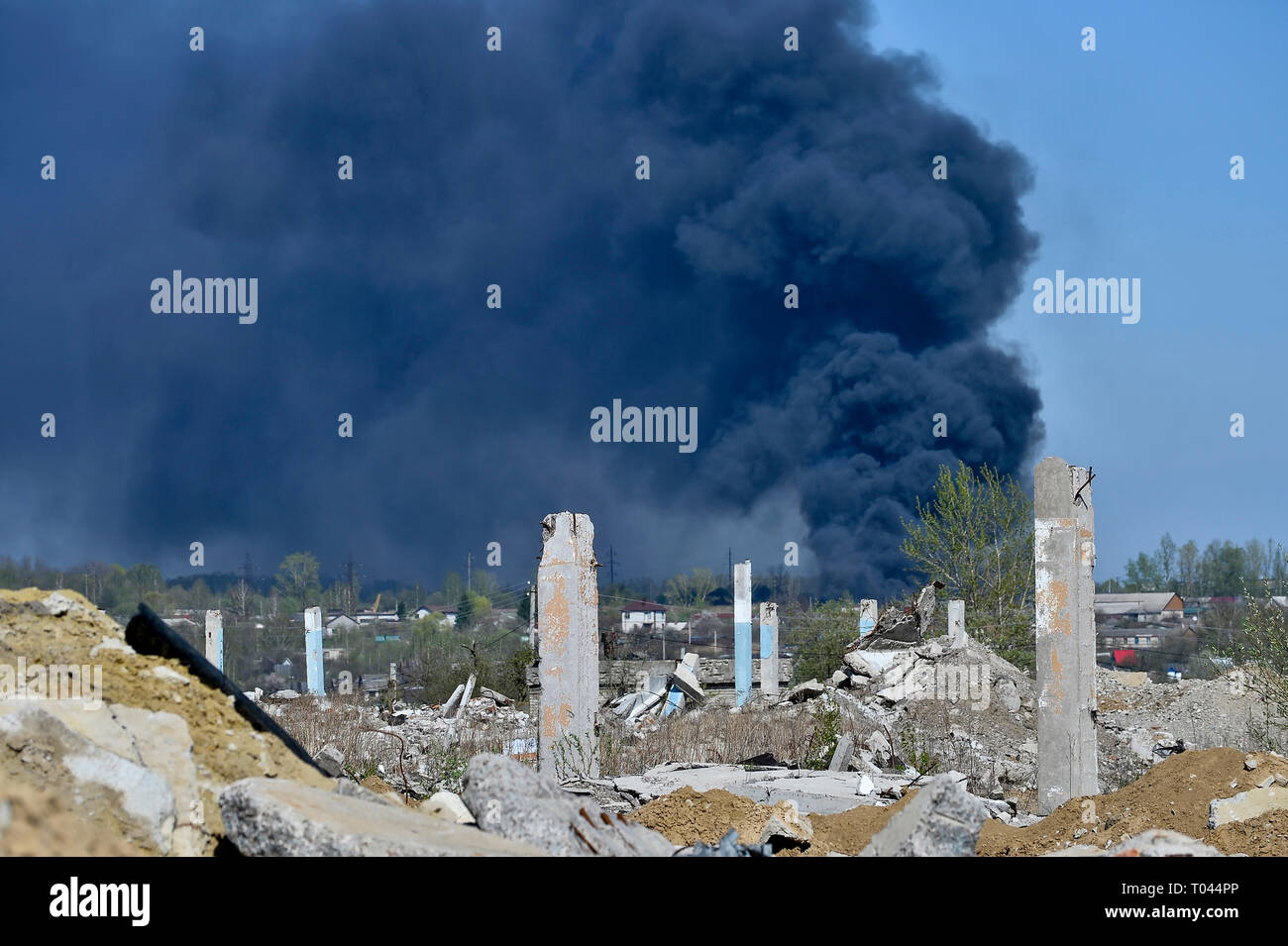 A pile of concrete rubble with protruding rebar on the background of ...