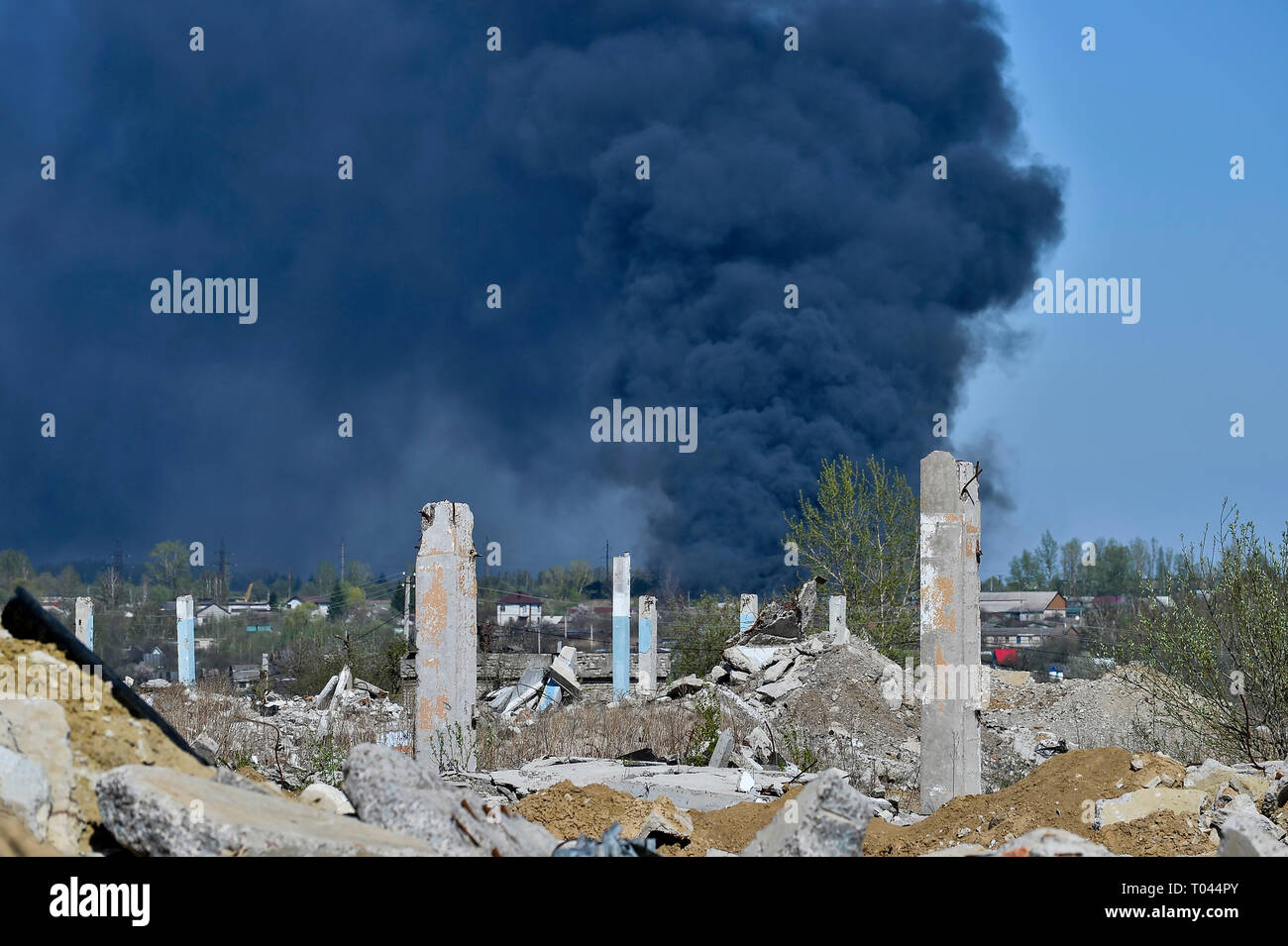 A pile of concrete rubble with protruding rebar on the background of ...