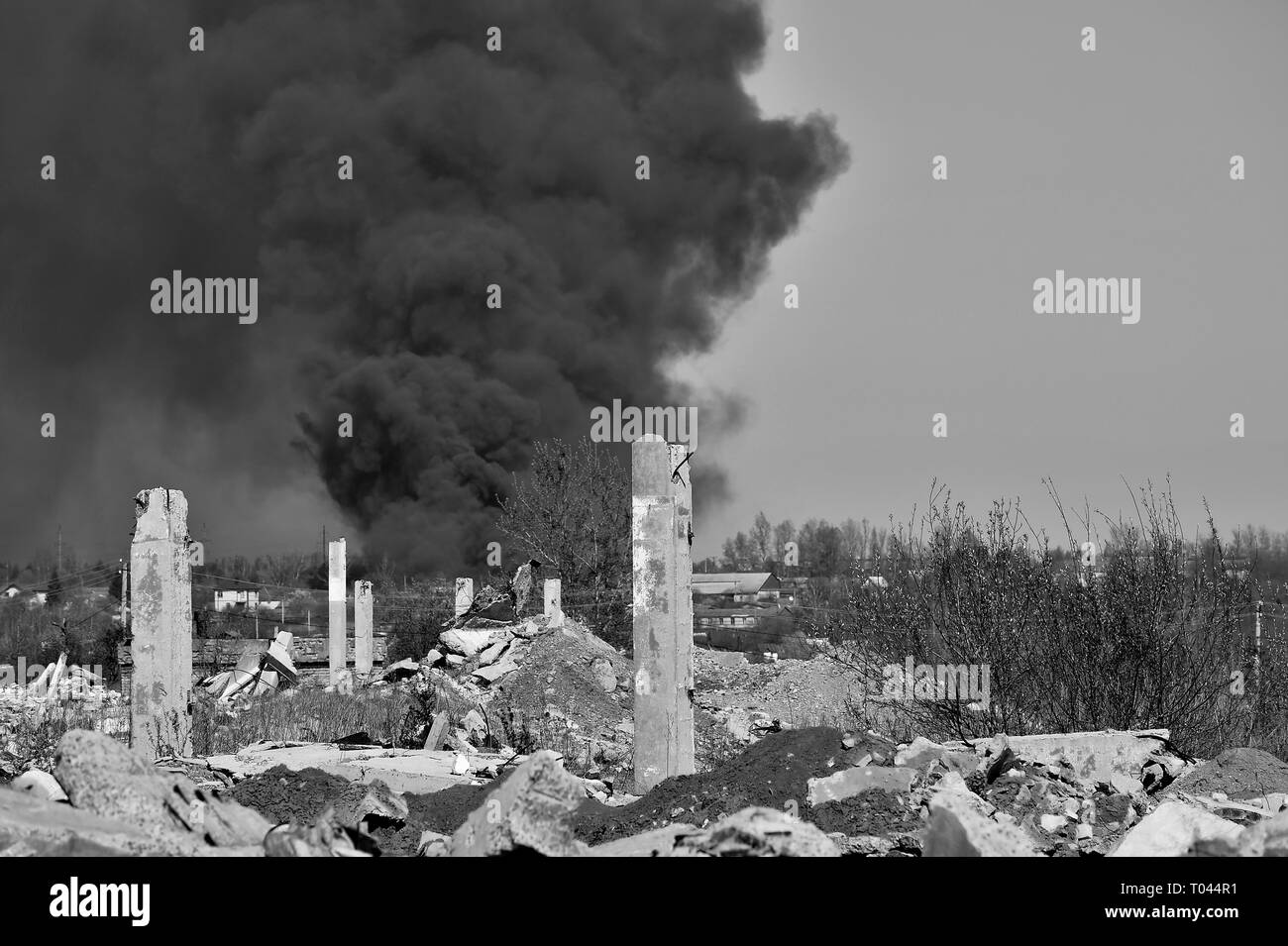 A pile of concrete rubble with protruding rebar on the background of ...