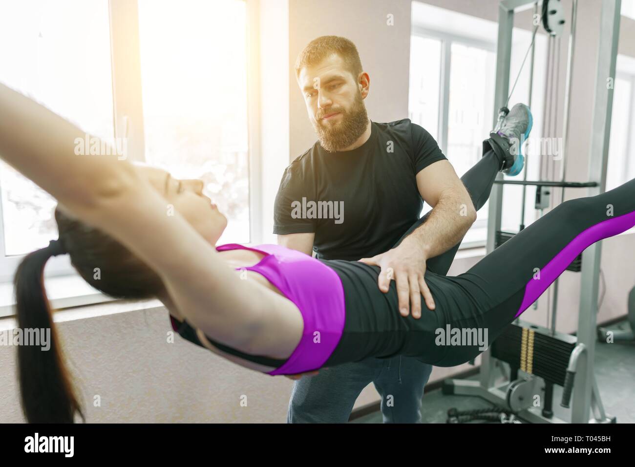 Kinesis technology, kinesitherapy, healthy lifestyle. Young woman doing ...