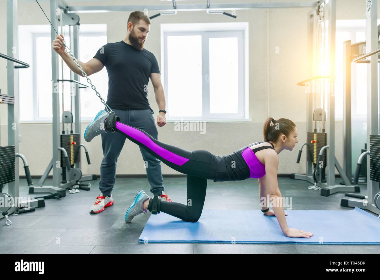 Kinesis technology, kinesitherapy, healthy lifestyle. Young woman doing ...