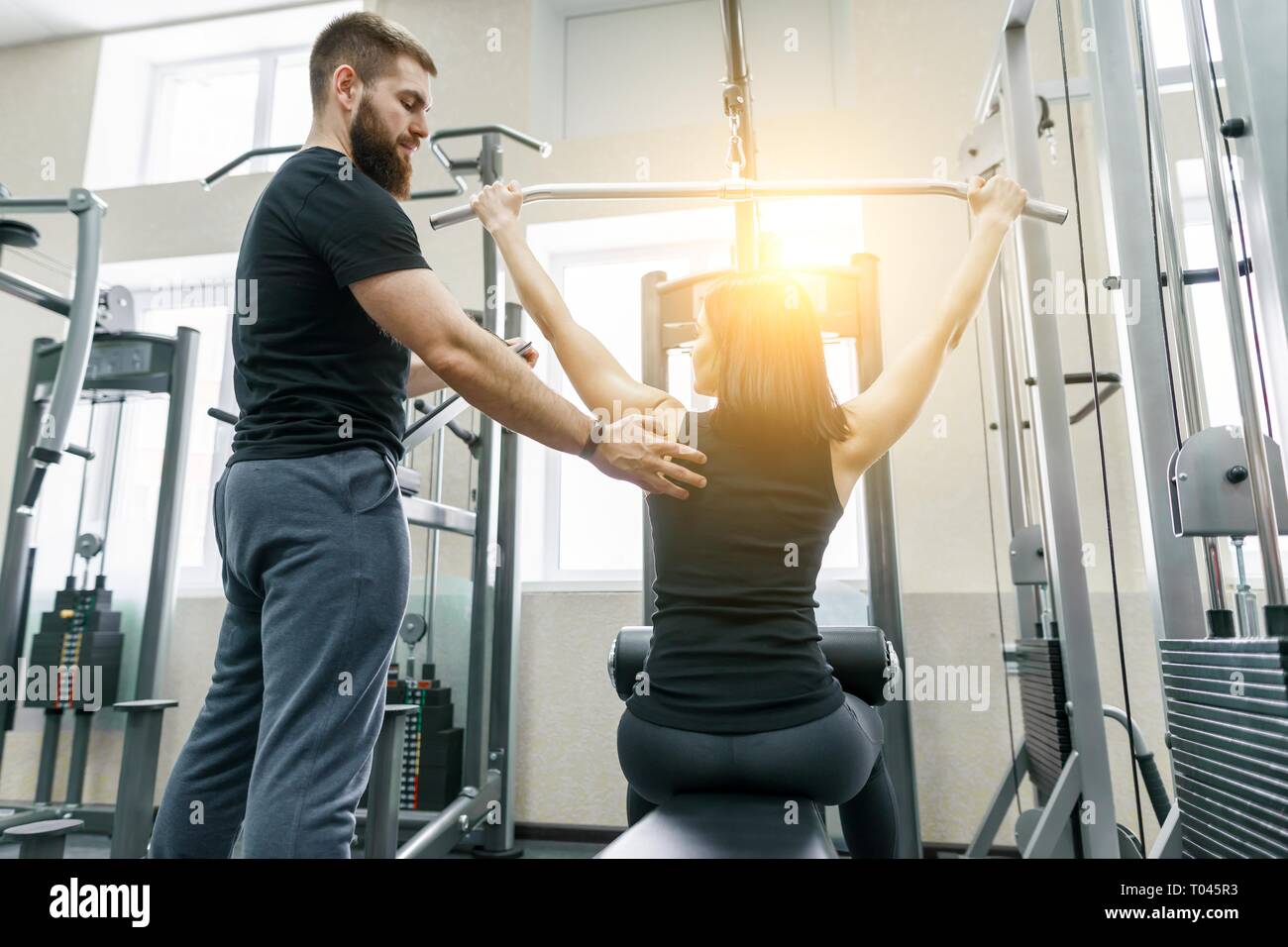 Personal fitness trainer coaching and helping client woman making ...