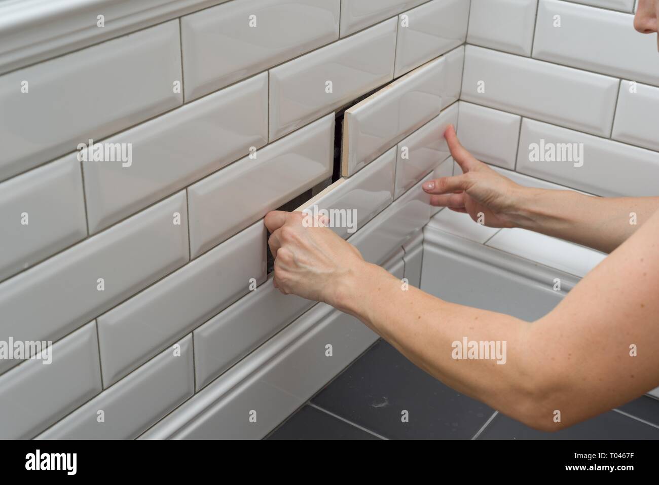 Woman opens, closes the hidden revision sanitary hatch on the wall of ...