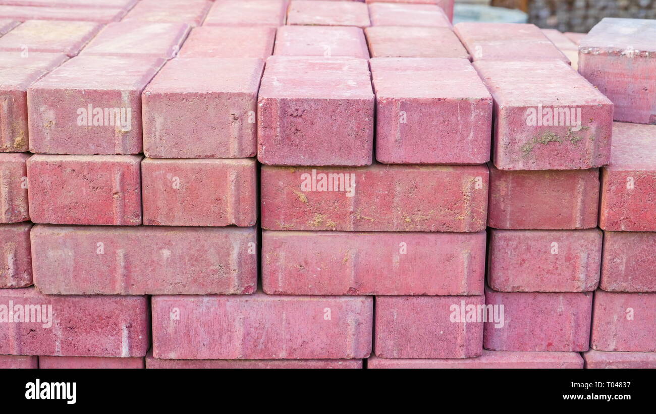 Piles of red bricks on the display bricks are used for wallings or ...