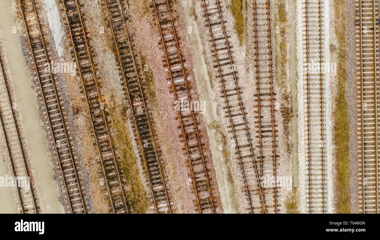 The aerial view of the old rusty rail tracks from old train station in ...