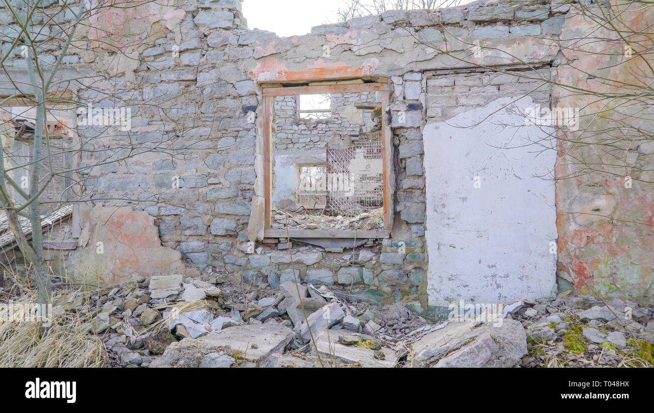 Ruined brick walls from the houses during war in ukraine seen the open ...